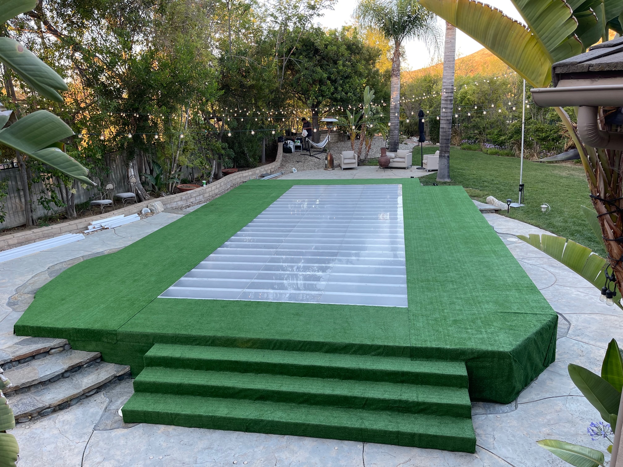 Deck over swimming pool for wedding ceremony and dance floor in Simil ...